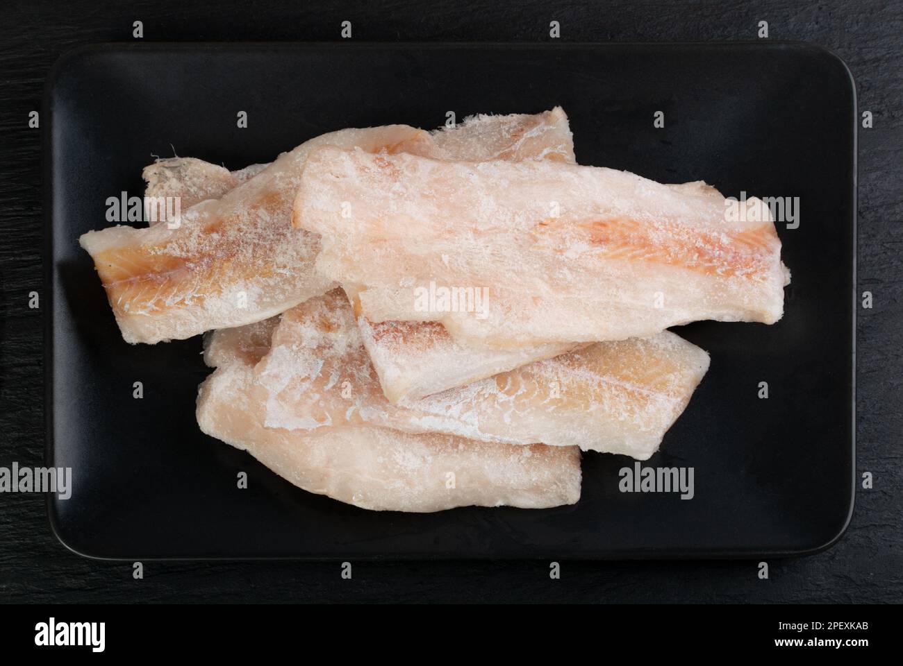 Frozen Fish on Black Plate, White Cod Fillet, Iced Hake Filet, Frozen ...
