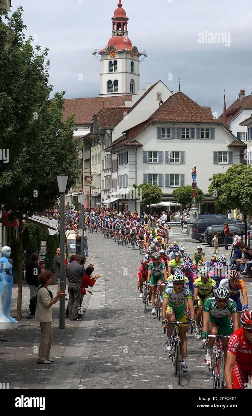 The pack rides through the town of Sursee, where the race started ...