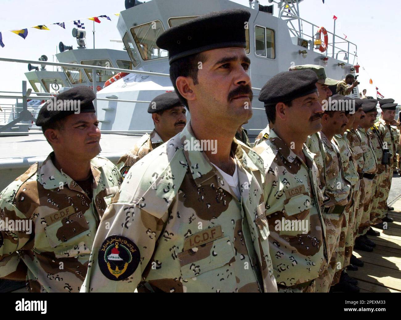 Iraqi sailors stand to attention during a handover ceremony from the ...