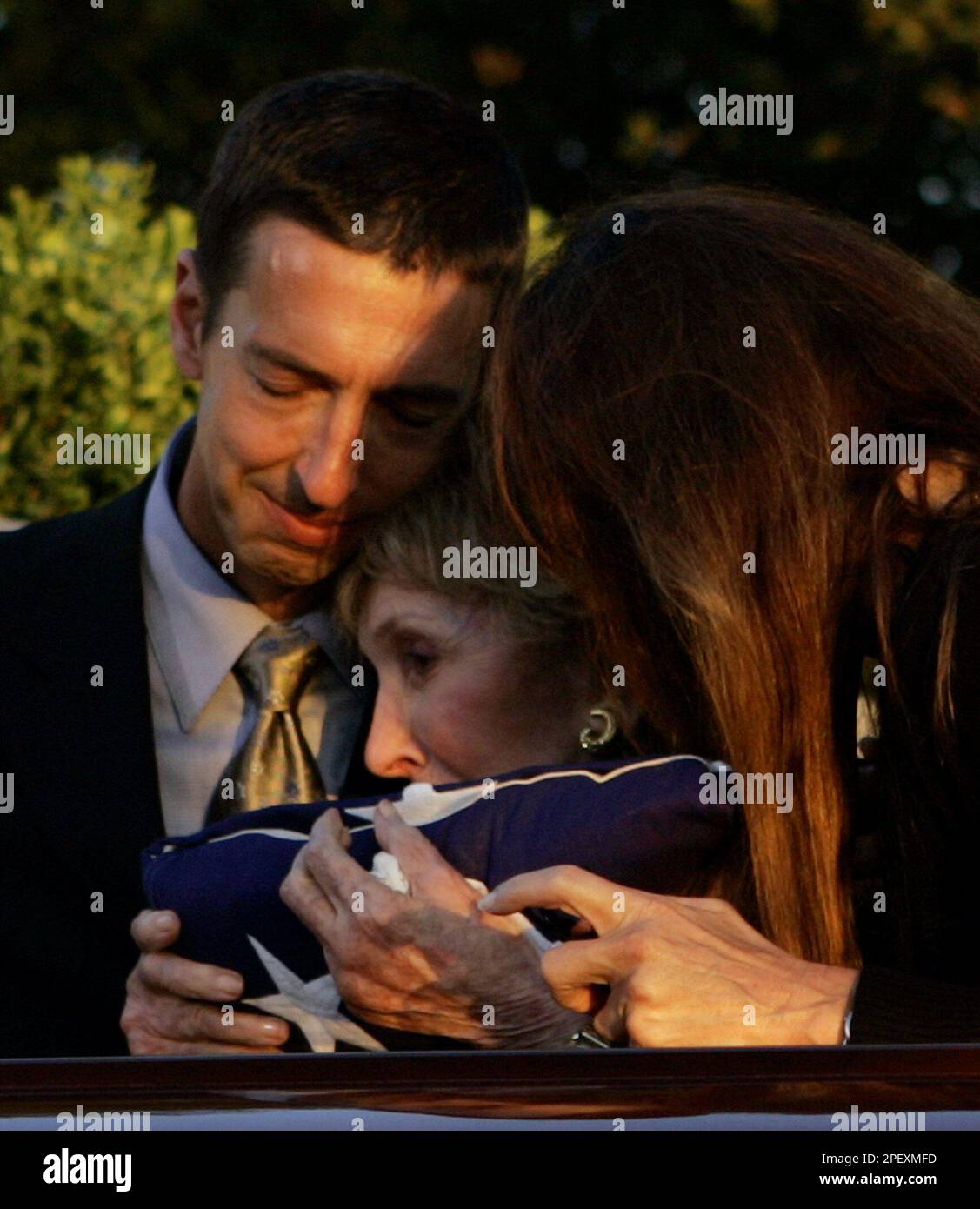Nancy Reagan is embraced by her children, Ron, left, and Patti, right ...