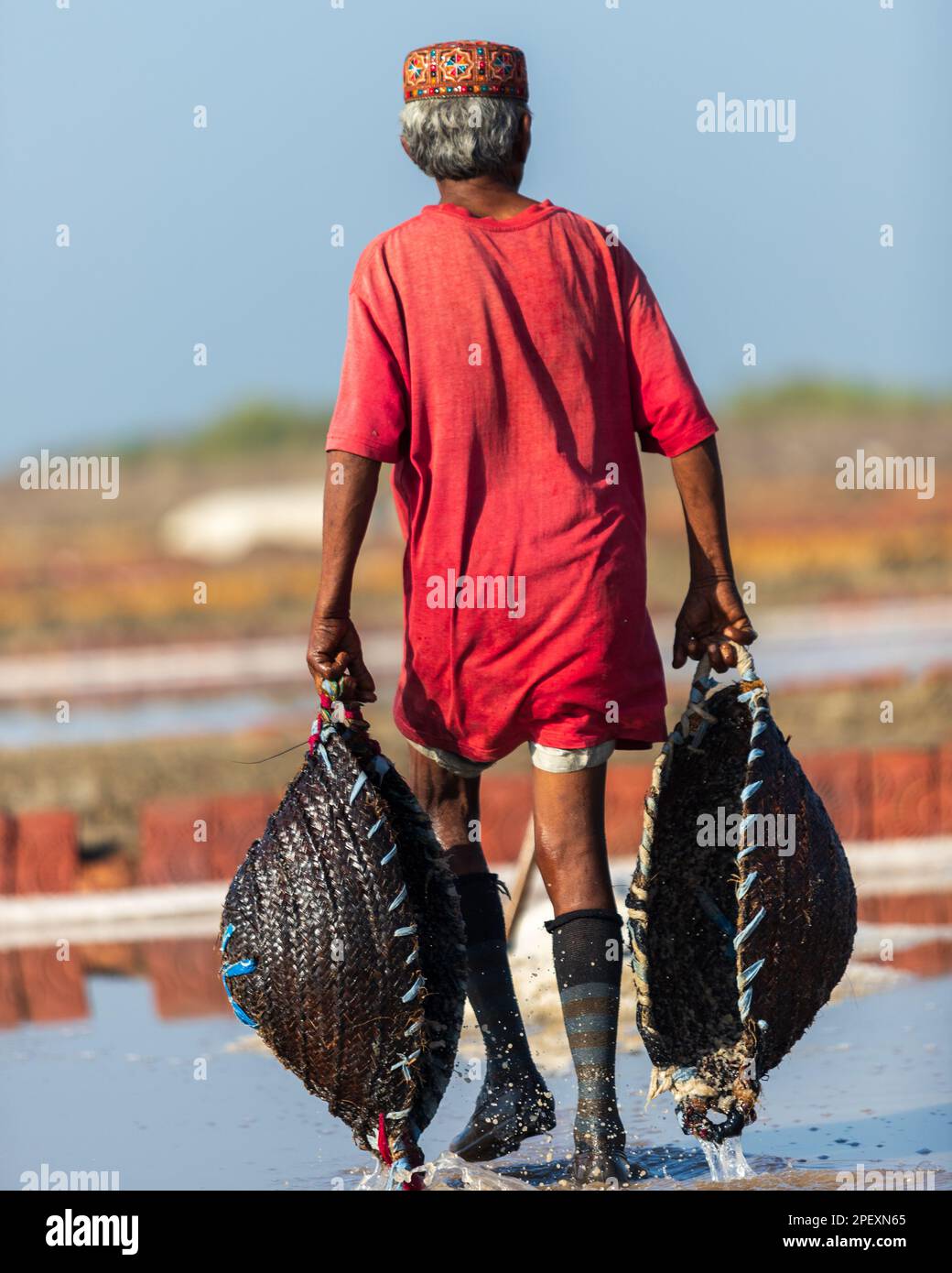 Bhambore Sindh Pakistan 2022, Labor collecting and stacking sea salt at ...