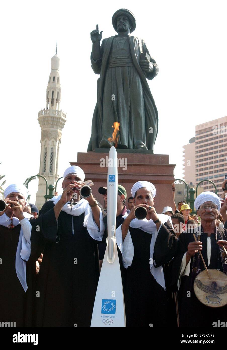 A traditional Egyptian music band plays in front of the Olympic torch ...