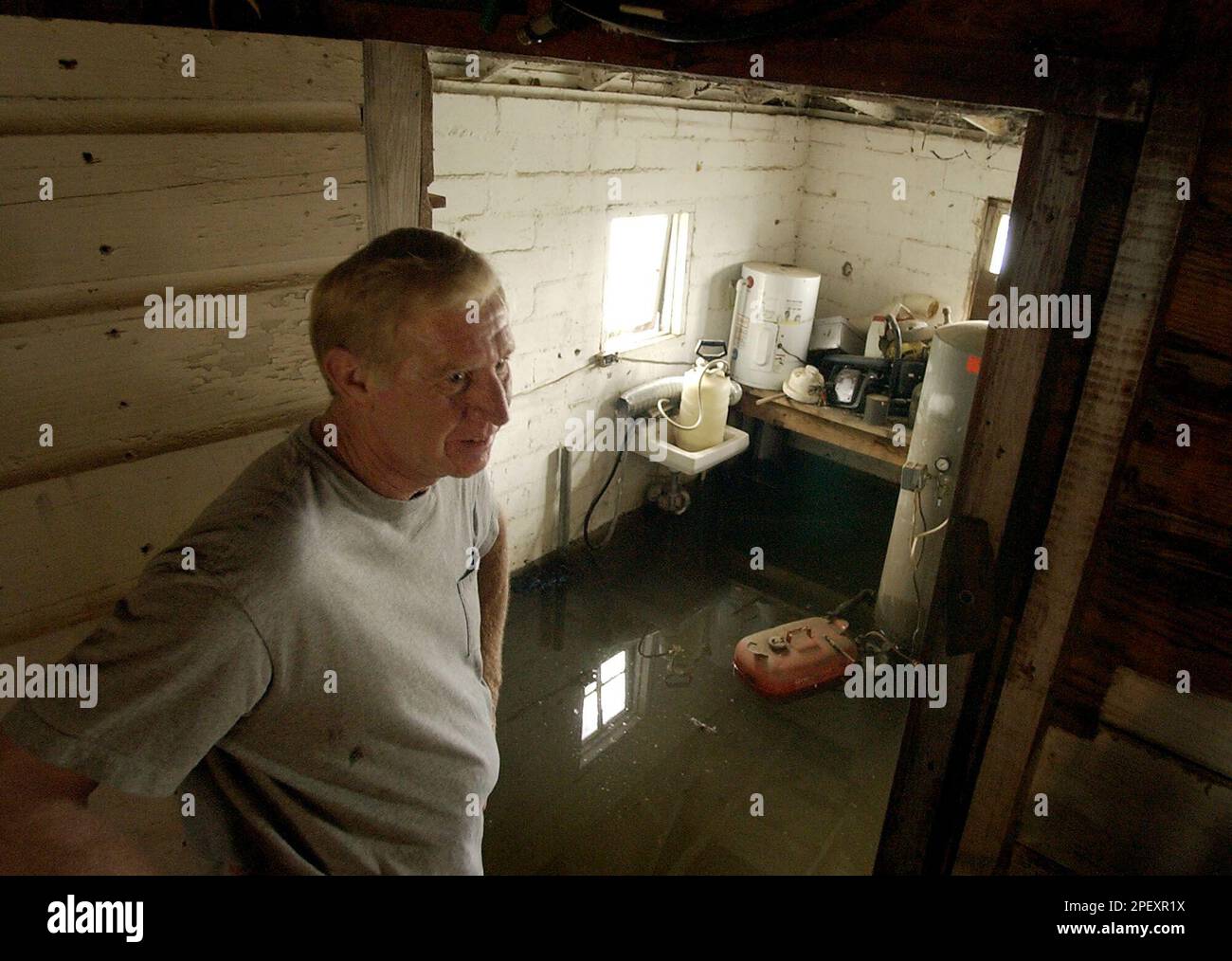Randy Barrow stands by his flooded utility room, Thursday, June 10 ...