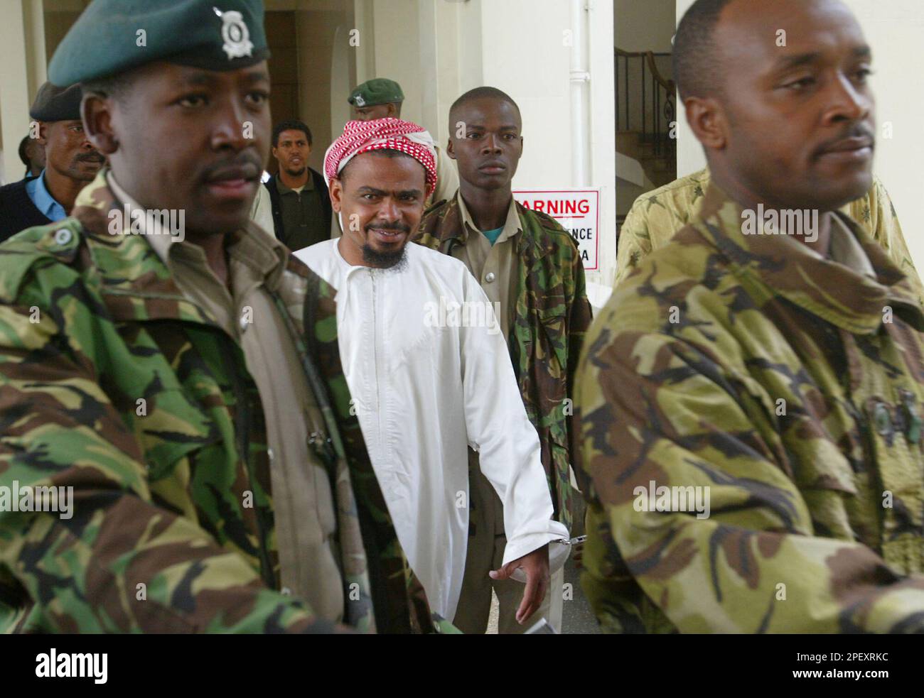 Kenyan police escourt Aboud Rogo, center, to a court in Nairobi, Kenya ...