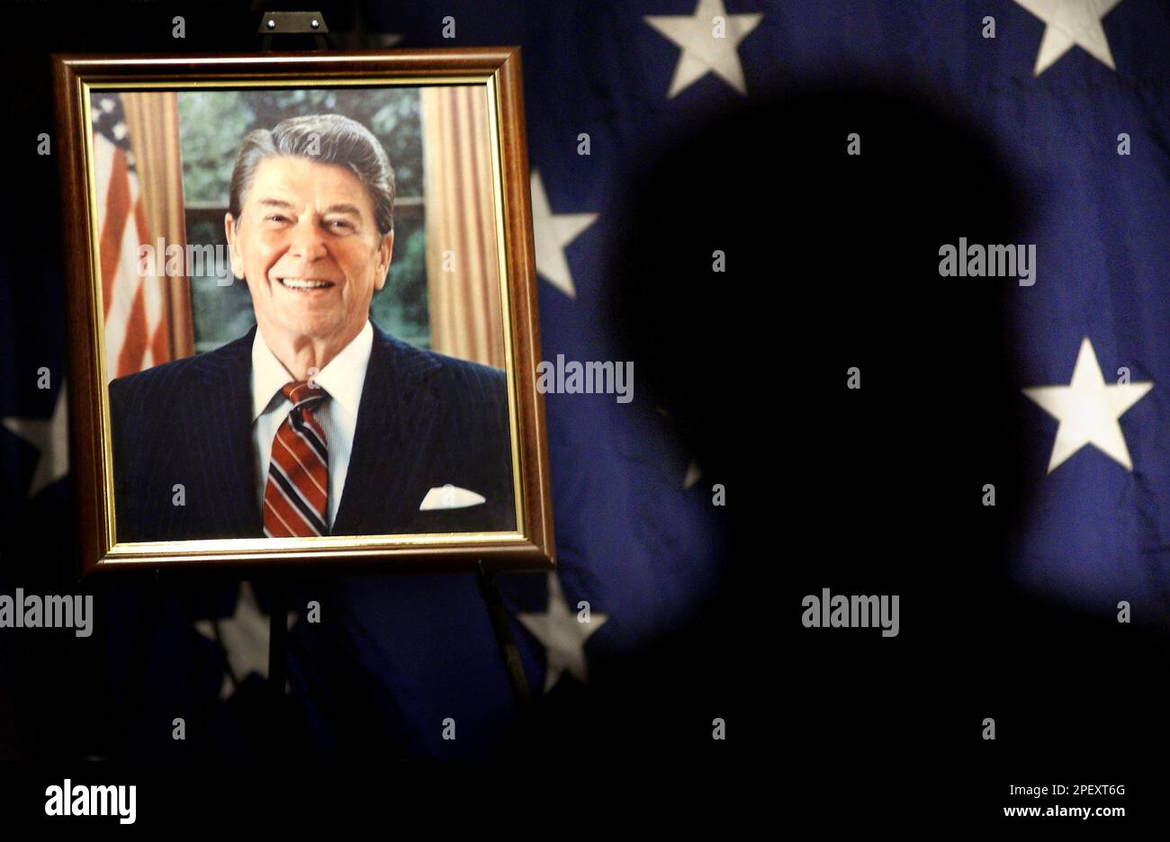 A portrait of former President Ronald Reagan is spot-lighted at the ...