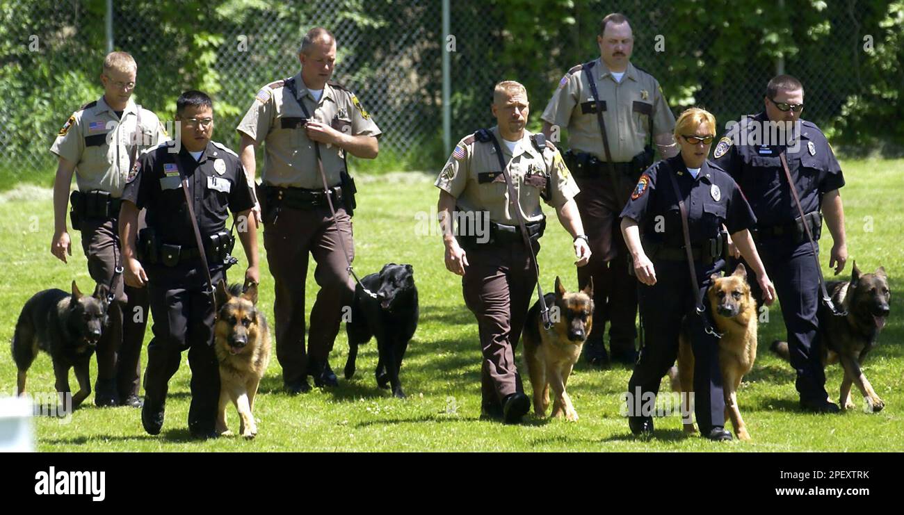 ** ADVANCE FOR WEEKEND OF JUNE 12-13 ** Members of the Spring 2004 Canine Graduating Class walk ...