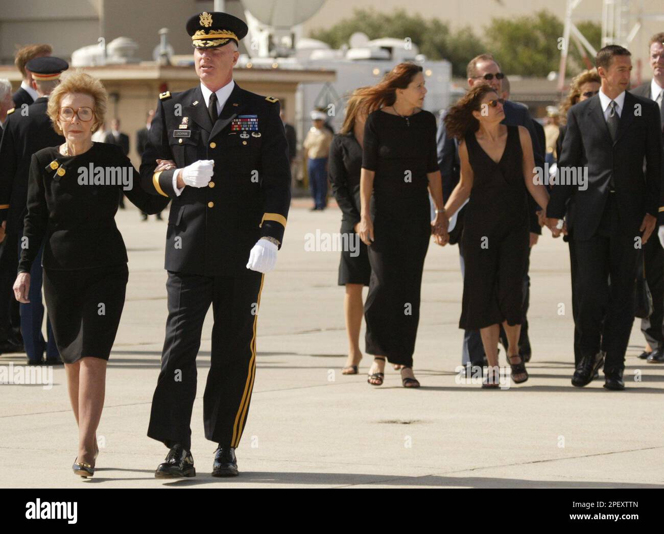 Nancy Reagan is escorted by Maj. Gen. Galen B. Jackman as former ...