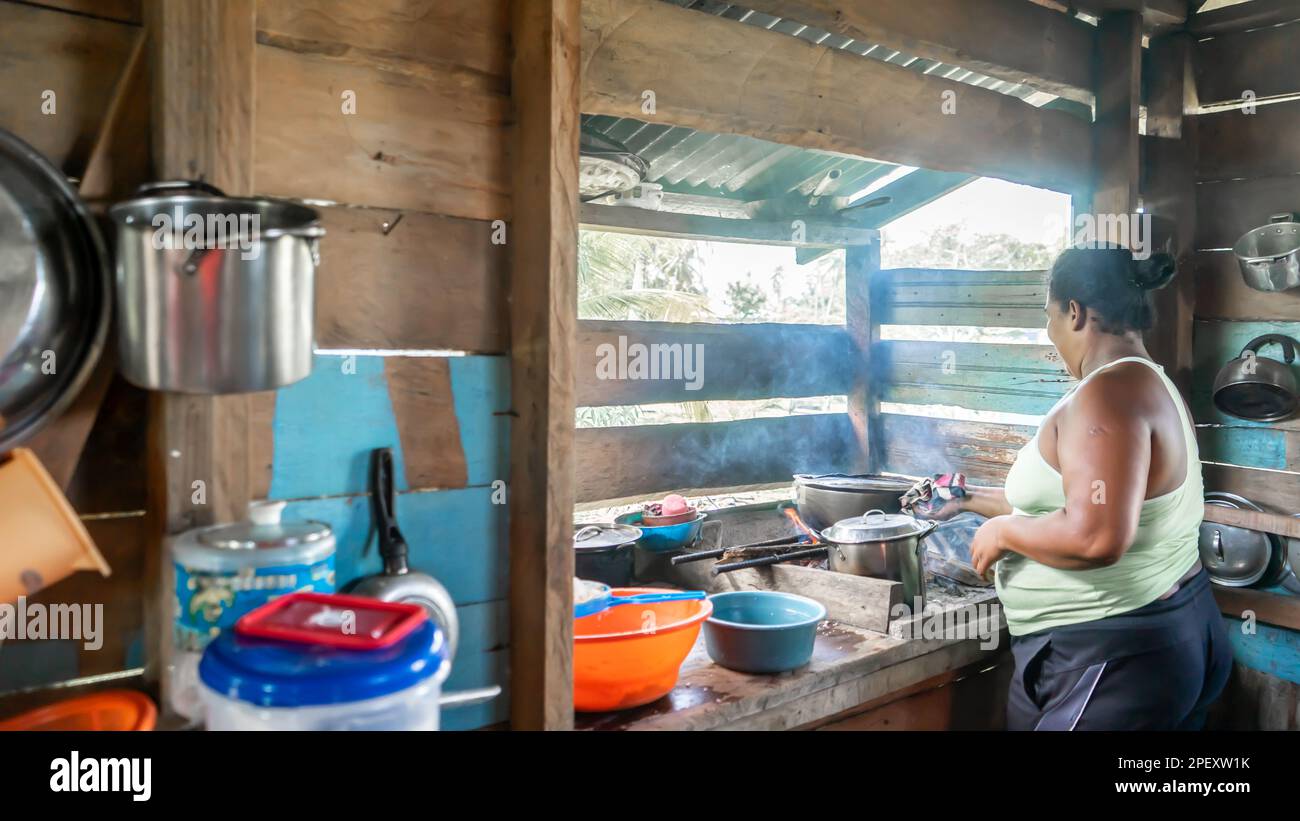 Afro-Caribbean woman cooking in her humble wooden dwelling in Nicaragua ...