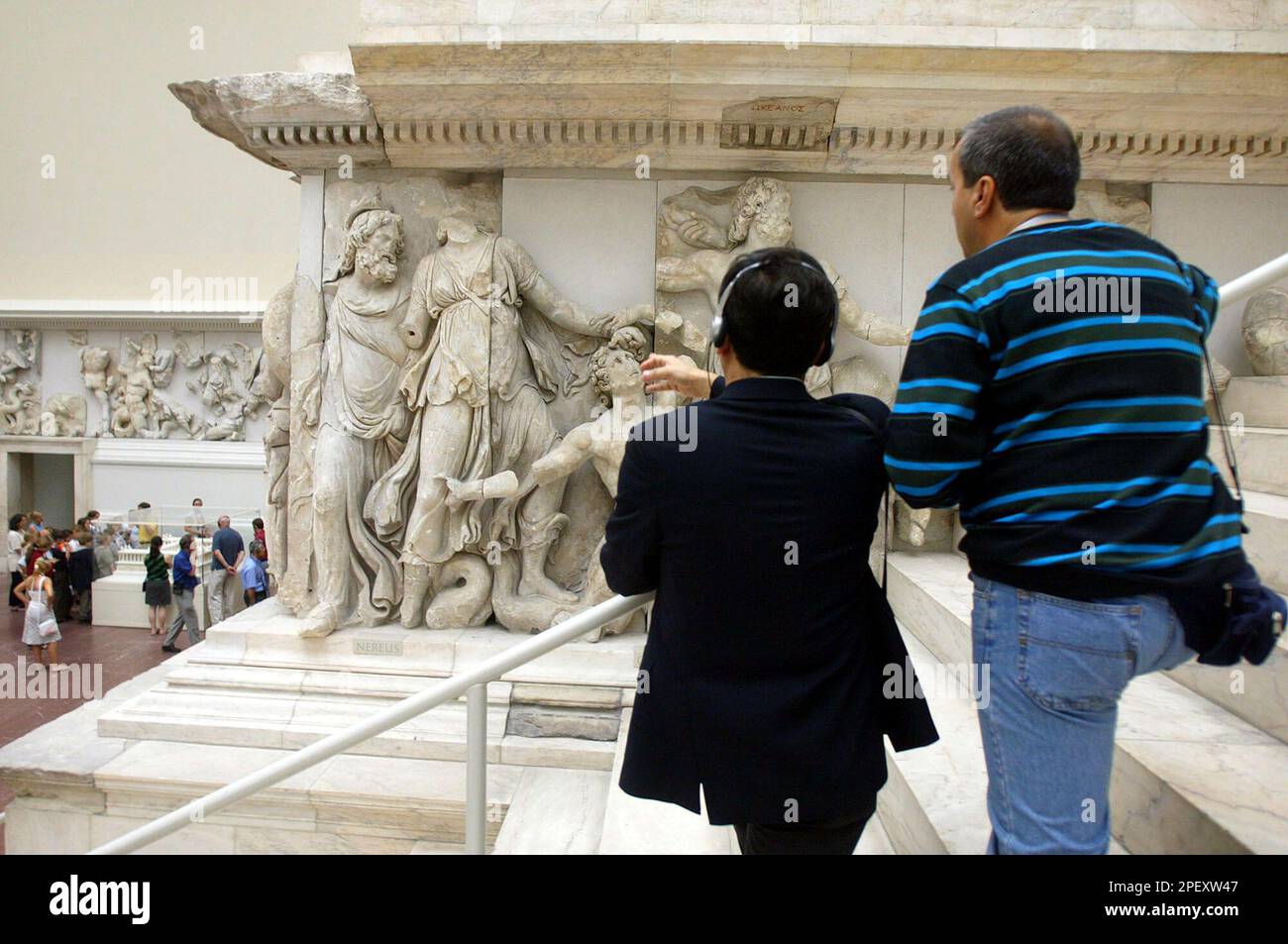 Two visitors look at the newly restored Pergamon frieze at the ...
