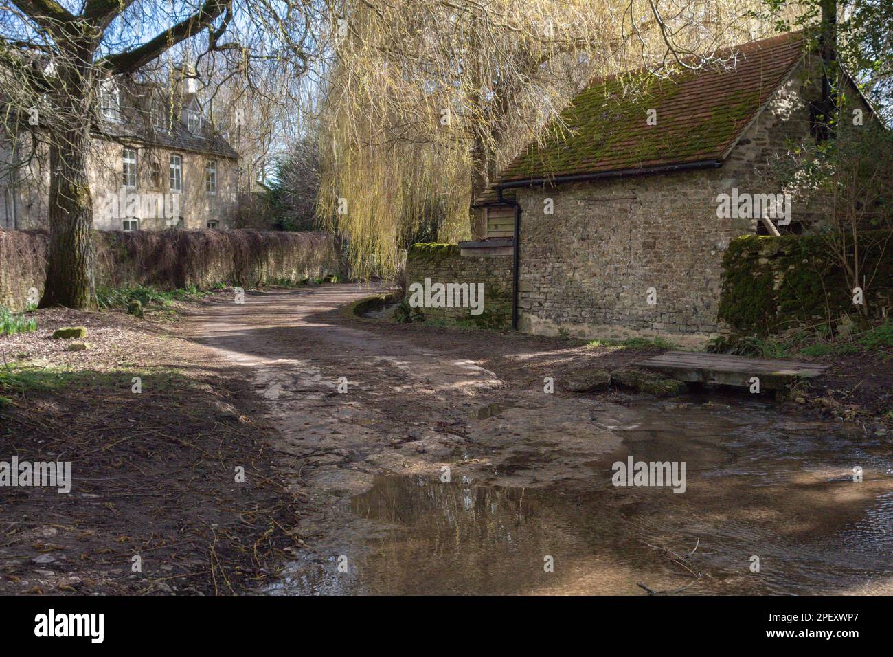 Village road and stream Stock Photo - Alamy
