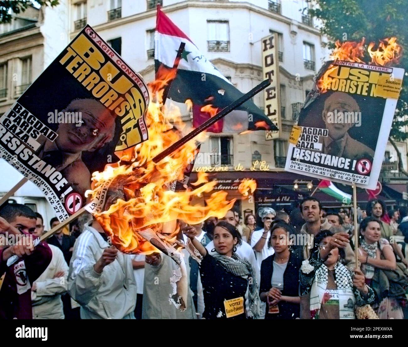 Demonstrators burn posters depicting U.S. President George W. Bush as ...