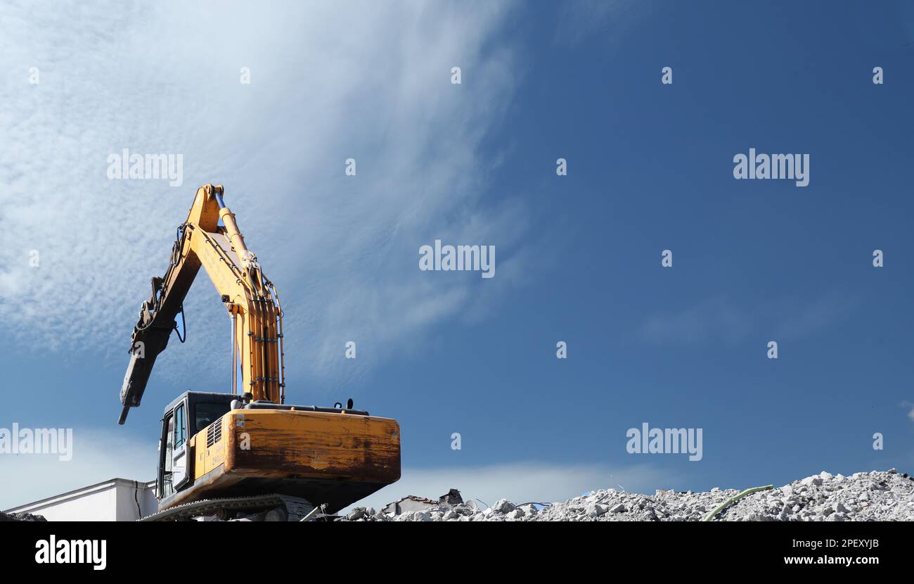Excavator at demolition work with hydraulic breaker hammer. Excavator ...