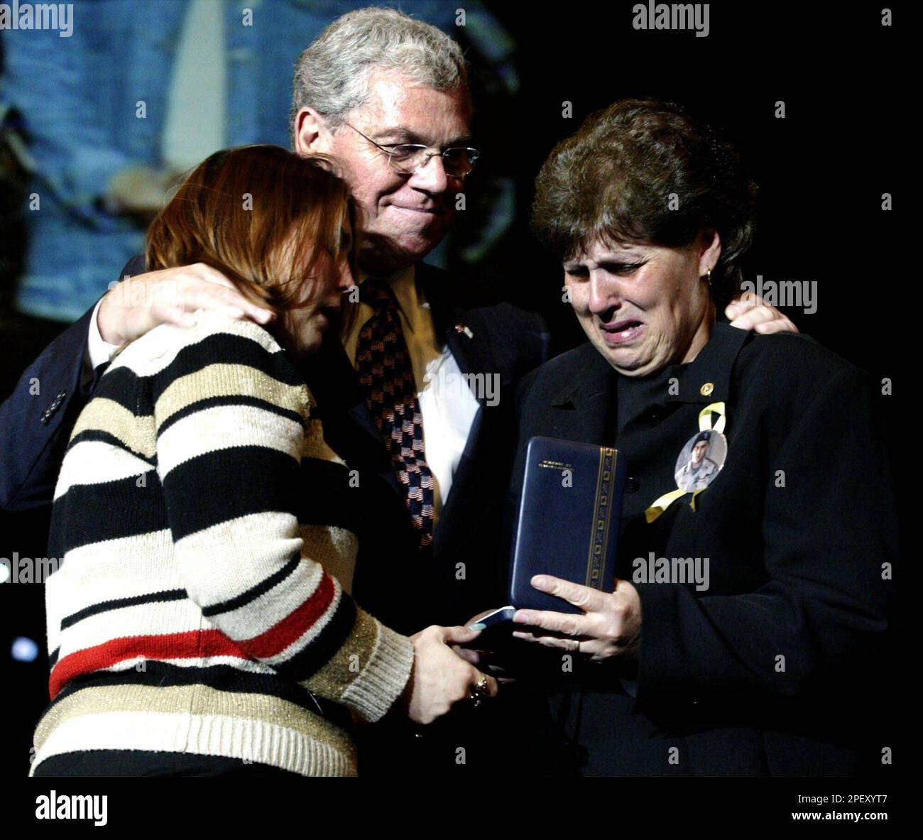 Rhode Island Gov. Donald Carcieri, center, hugs Michael Andrade's wife ...