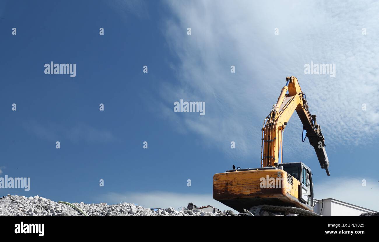 Excavator at demolition work with hydraulic breaker hammer. Excavator ...