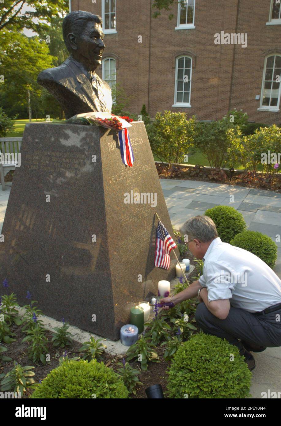 Dr. Terry Ewing, chaplain of Eureka College, lights candles Saturday ...