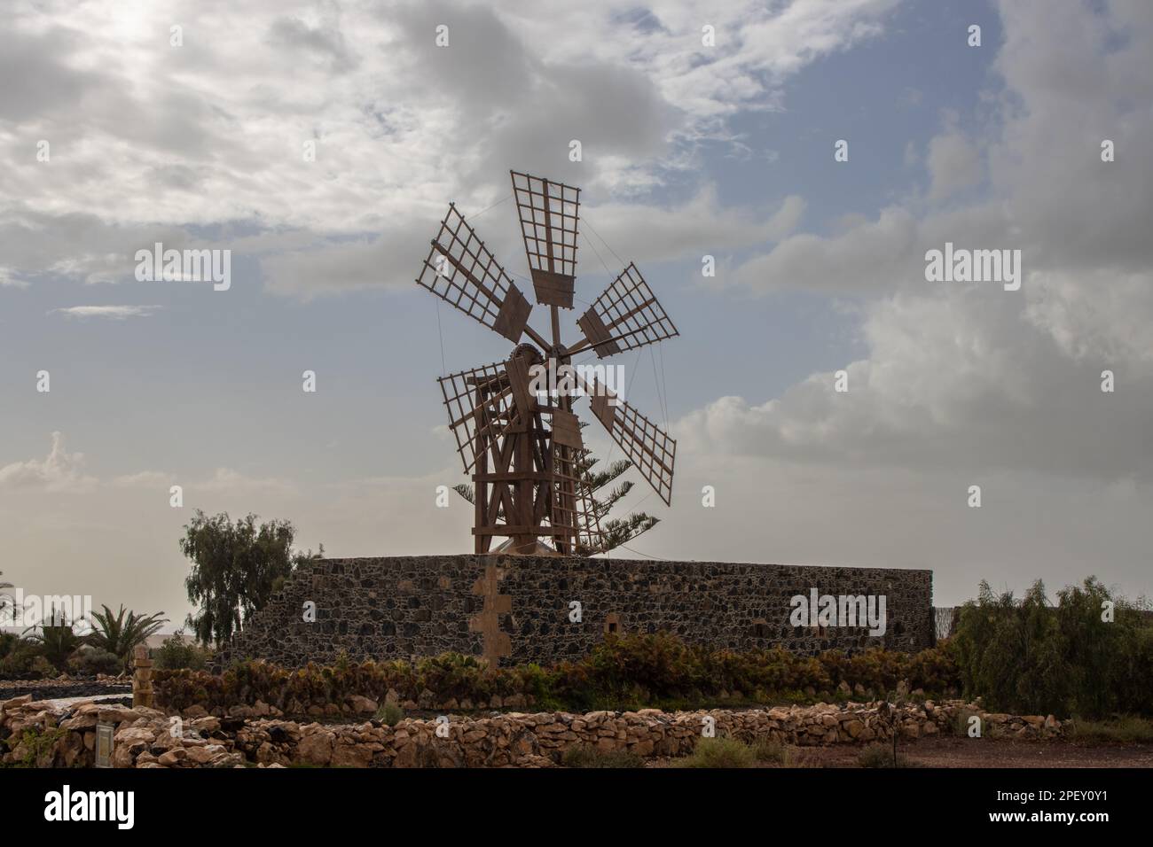 Old well preserved windmill with a stone base. Early evening mood. Blue ...