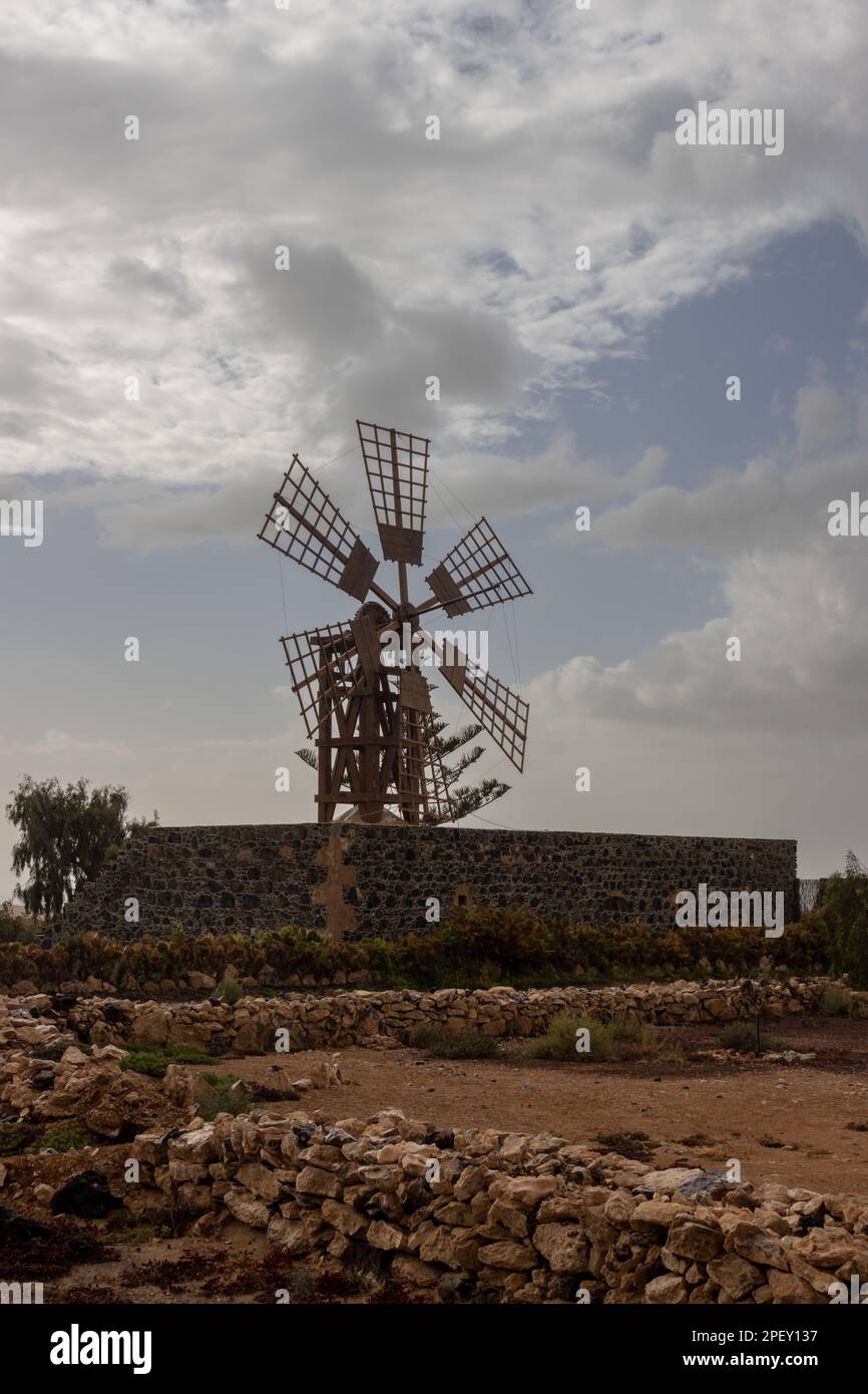 Old well preserved windmill with a stone base. Early evening mood. Blue ...