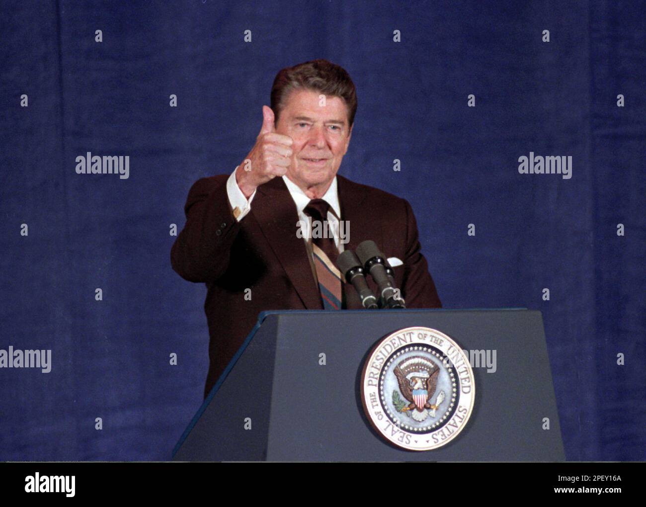 President Ronald Reagan gives thumbs up sign during a speech in ...