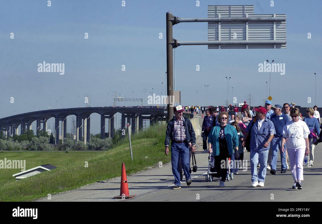 Walkers approach the end of their journey across the Zilwaukee Bridge ...