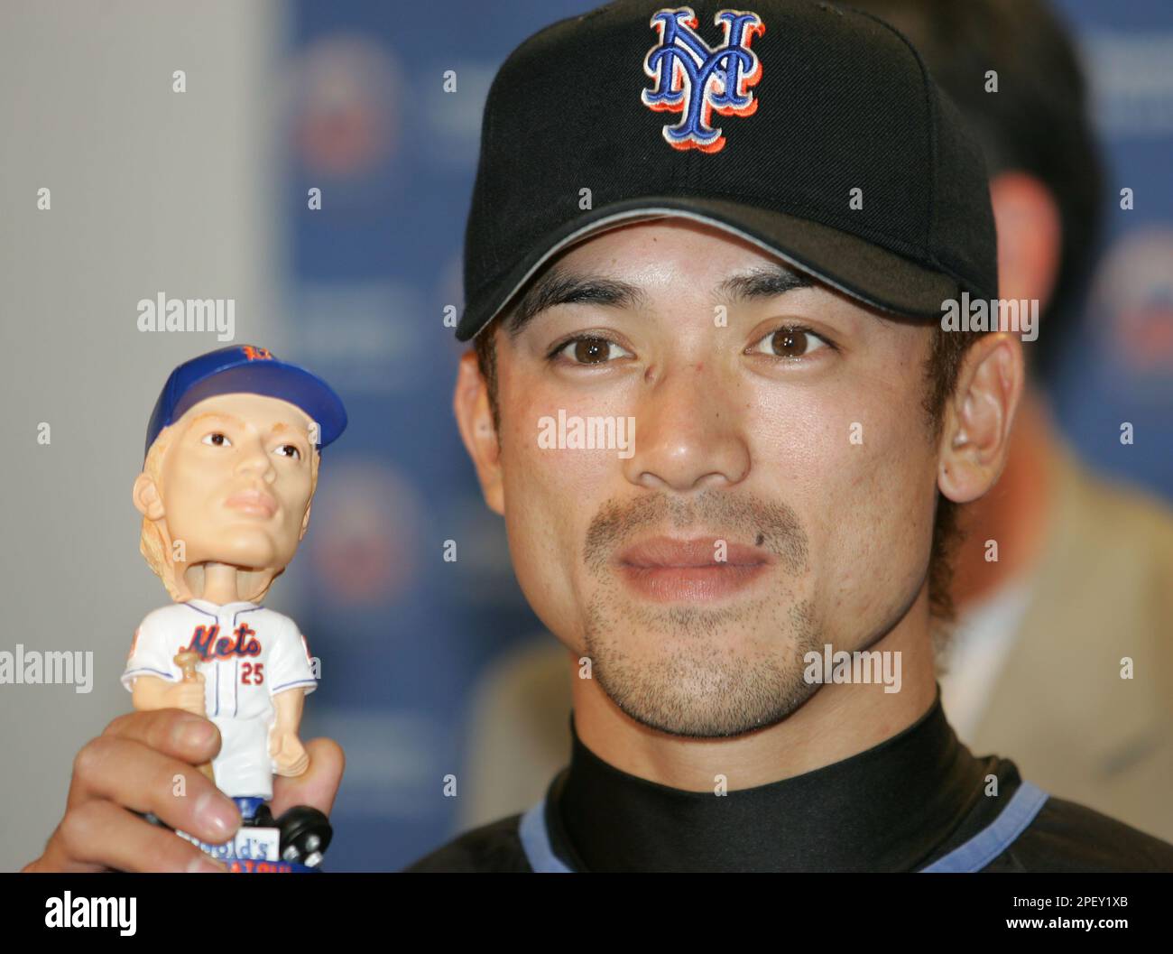New York Mets' Kaz Matsui holds a Kaz Matsui bobble head doll during a ...
