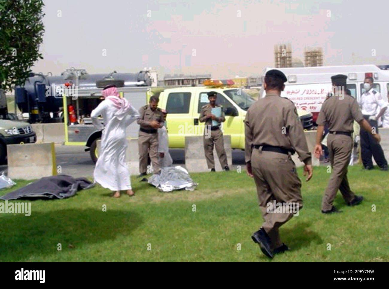 Saudi police and security watch the covered dead bodies of victims at ...