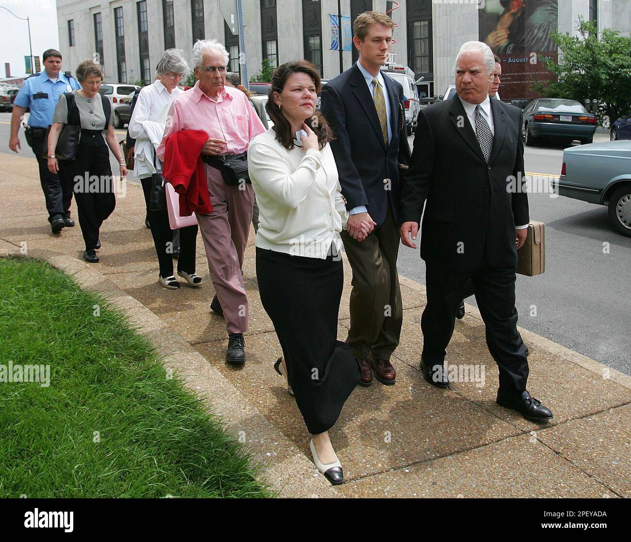 Joanna Ediger, center, holds hands with her husband Matt, right, as ...