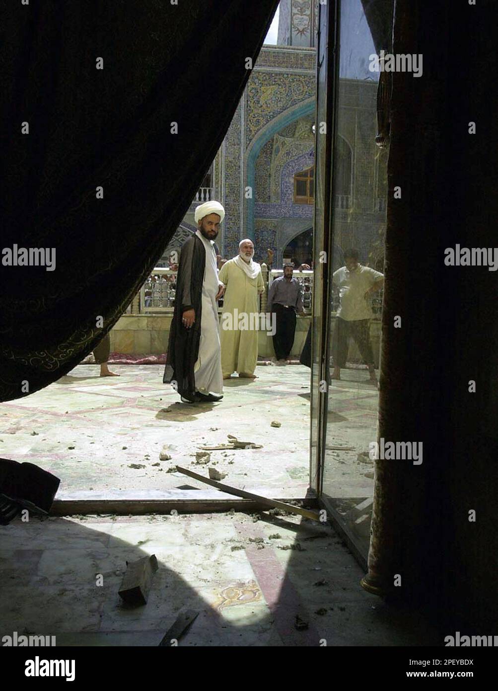 Iraqi Shiite clerics inspect the damage after one of the most sacred ...