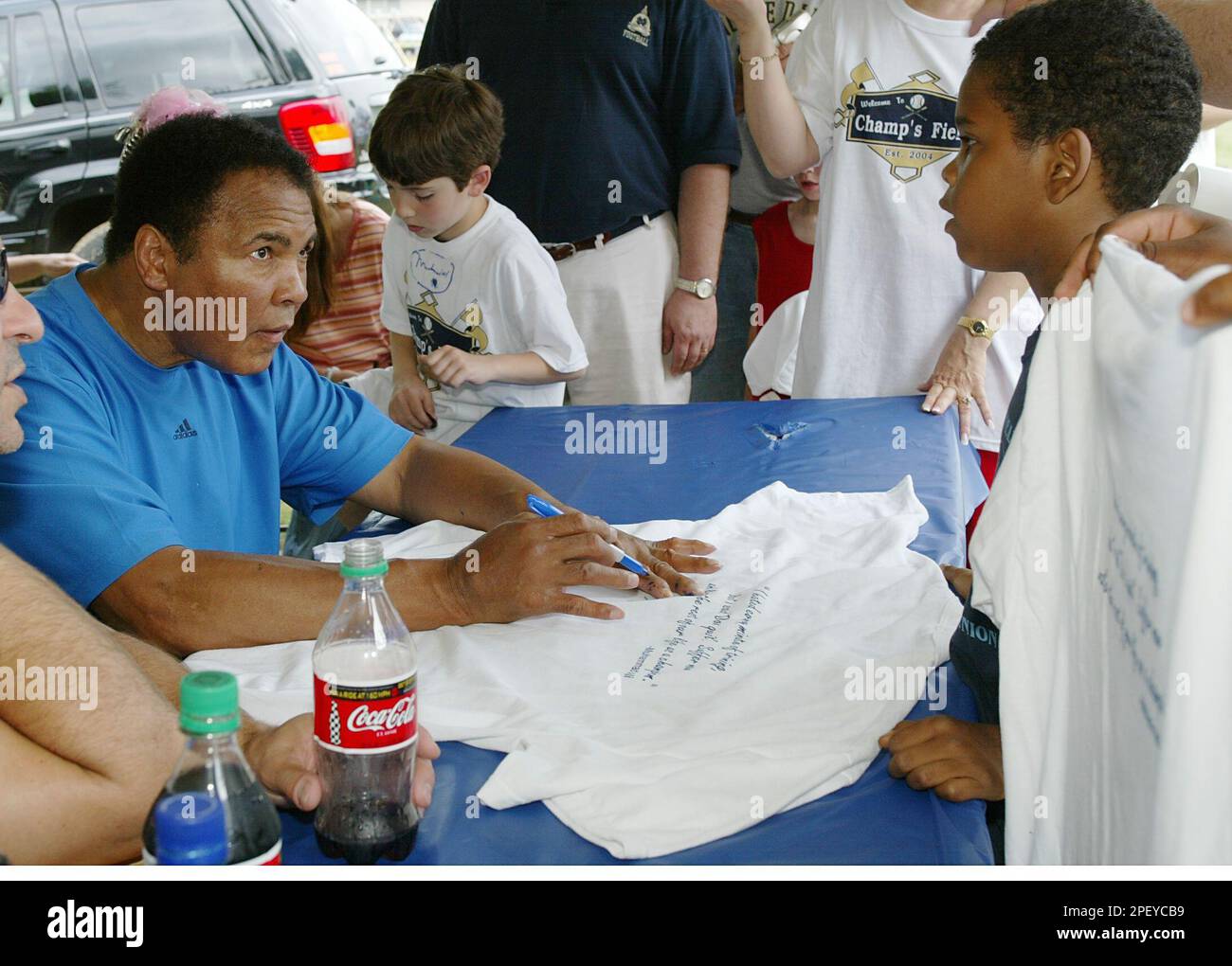 Muhammad Ali autographs a T-shirt for 8-year-old Trevon Brown of ...