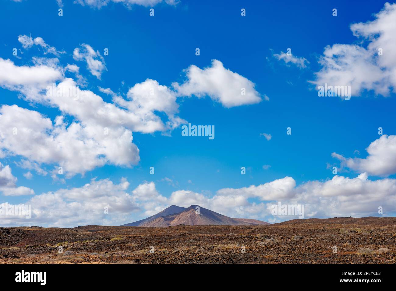 Volcanic hills complete the typical landscape of Fuerteventura in the ...
