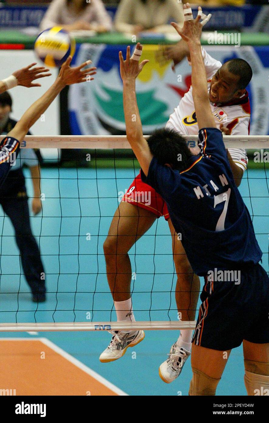 Japan's Marcos Sugiyama, right, spikes the ball against China's Tang ...