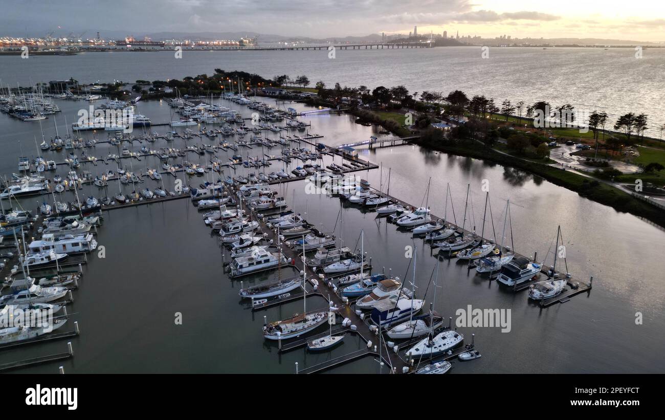 A picturesque scene of a harbor at dusk with the sun setting in the ...