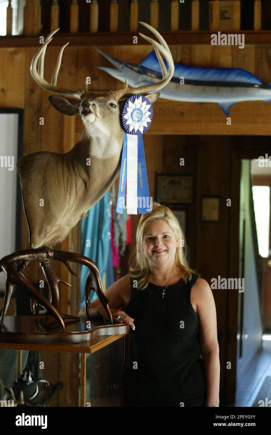 Mary Coombs poses with her first taxidermy mount in her home in ...