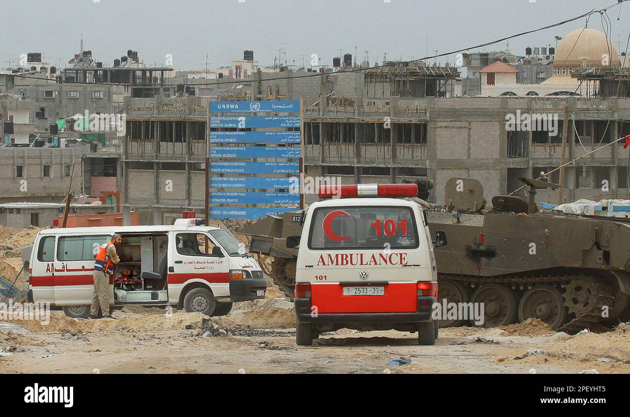 A Palestinian ambulance driver shows soldiers an injured man inside the ...