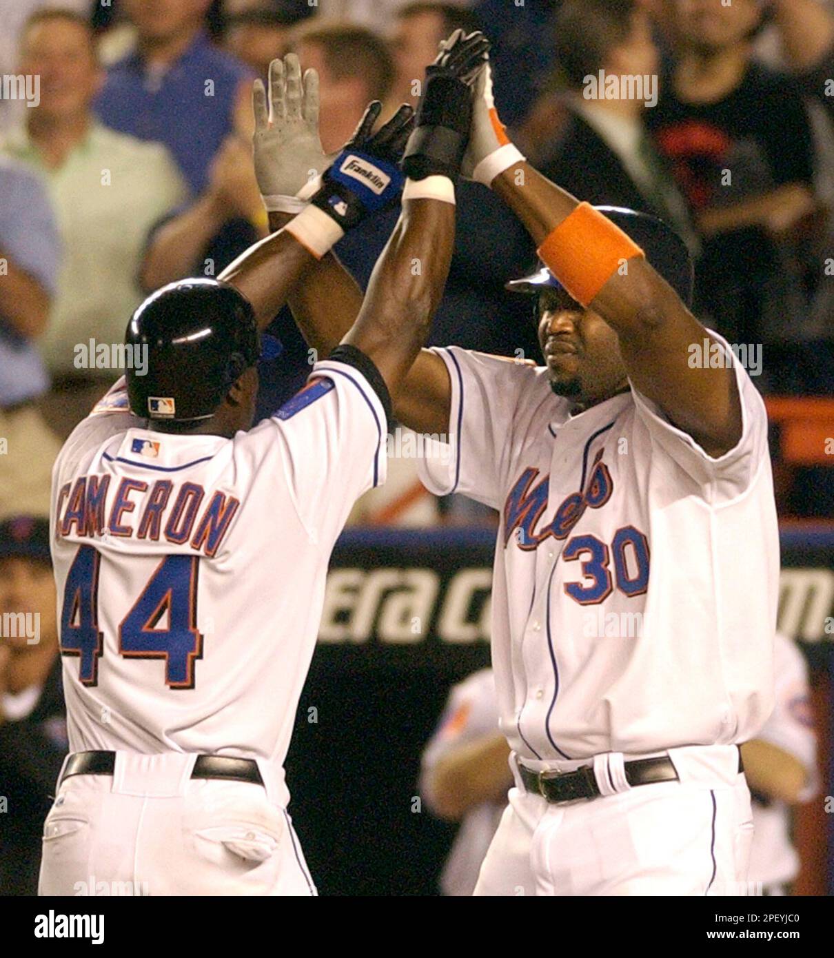 New York Mets' Cliff Floyd, right, greets Mike Cameron after Cameron ...