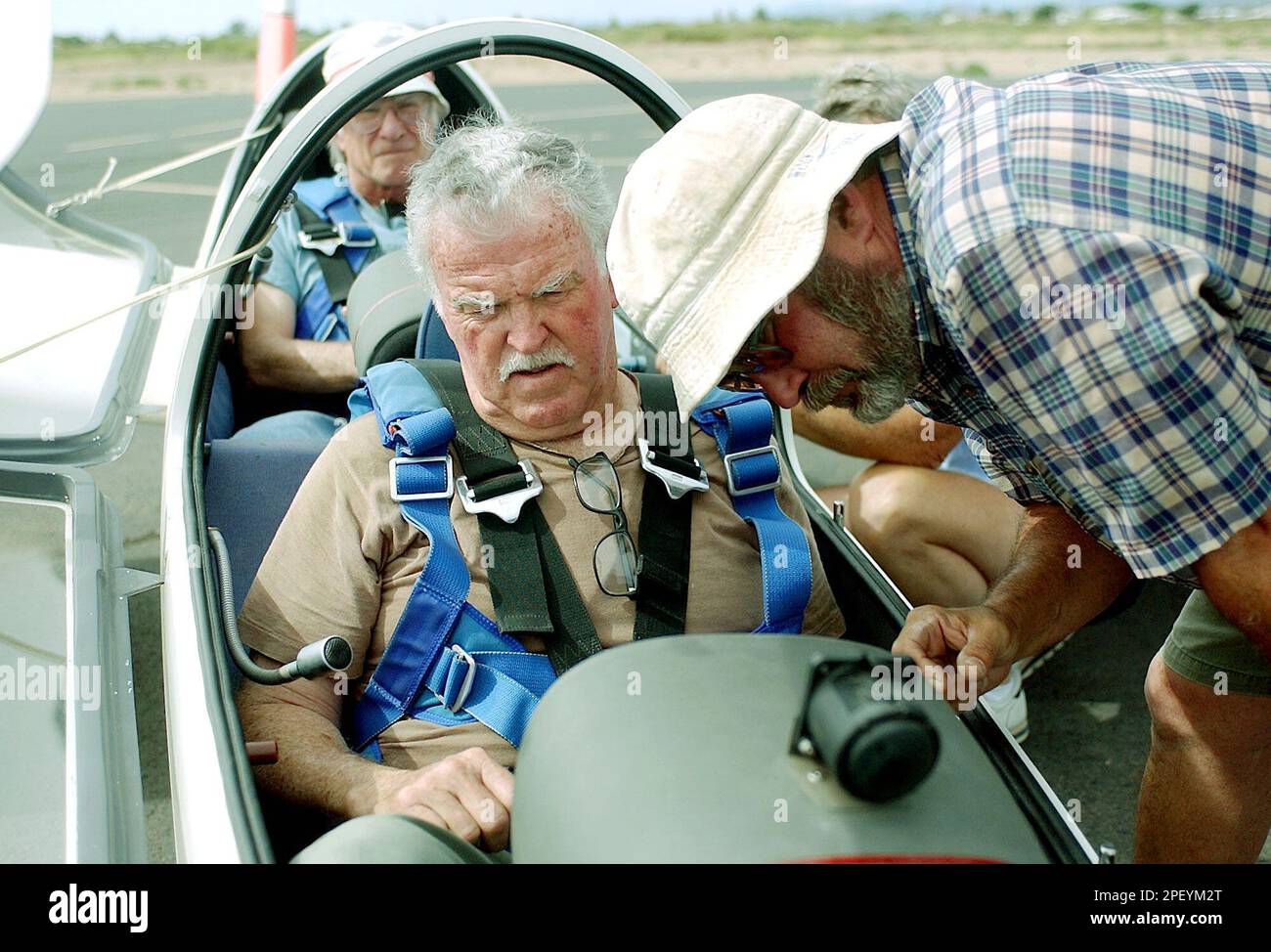 George Fish, right, shows passenger John Duggan, center, the controls ...