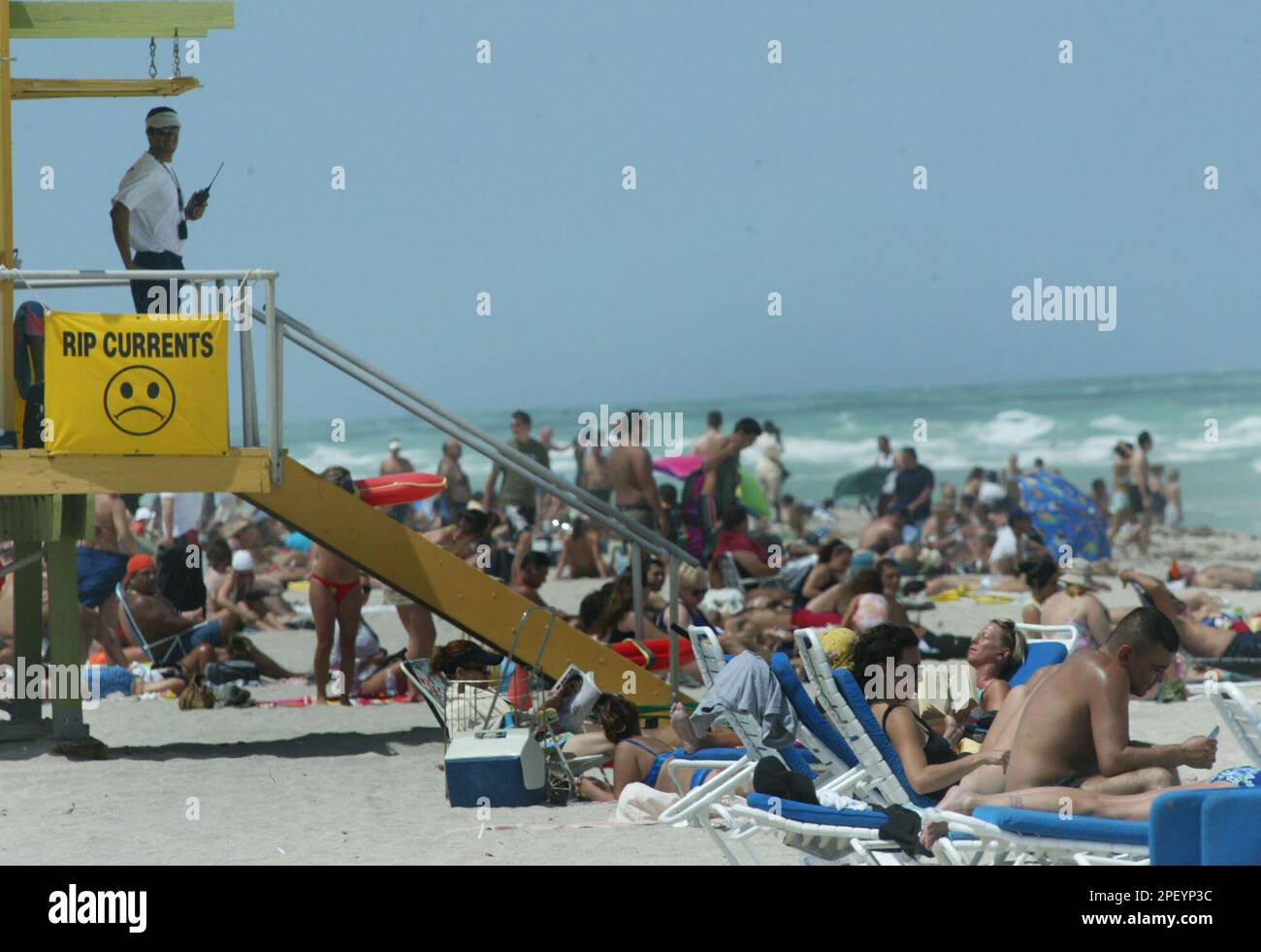 A lifeguard watches beach goers Friday, May 14, 2004, in Miami Beach ...