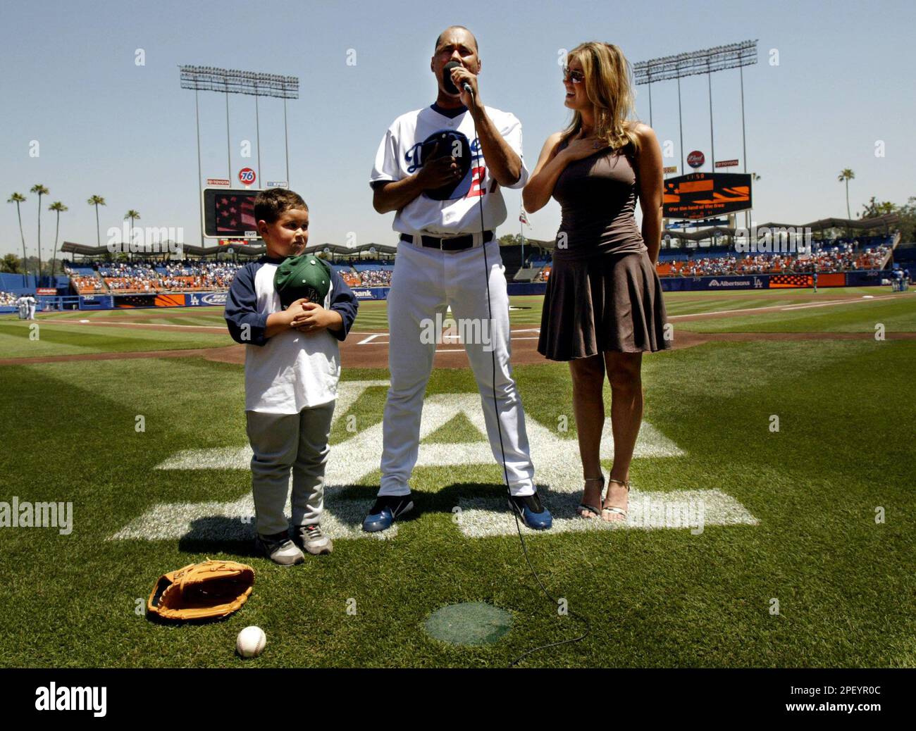 Los Angeles Dodgers pitcher Jose Lima, center, sings the national ...