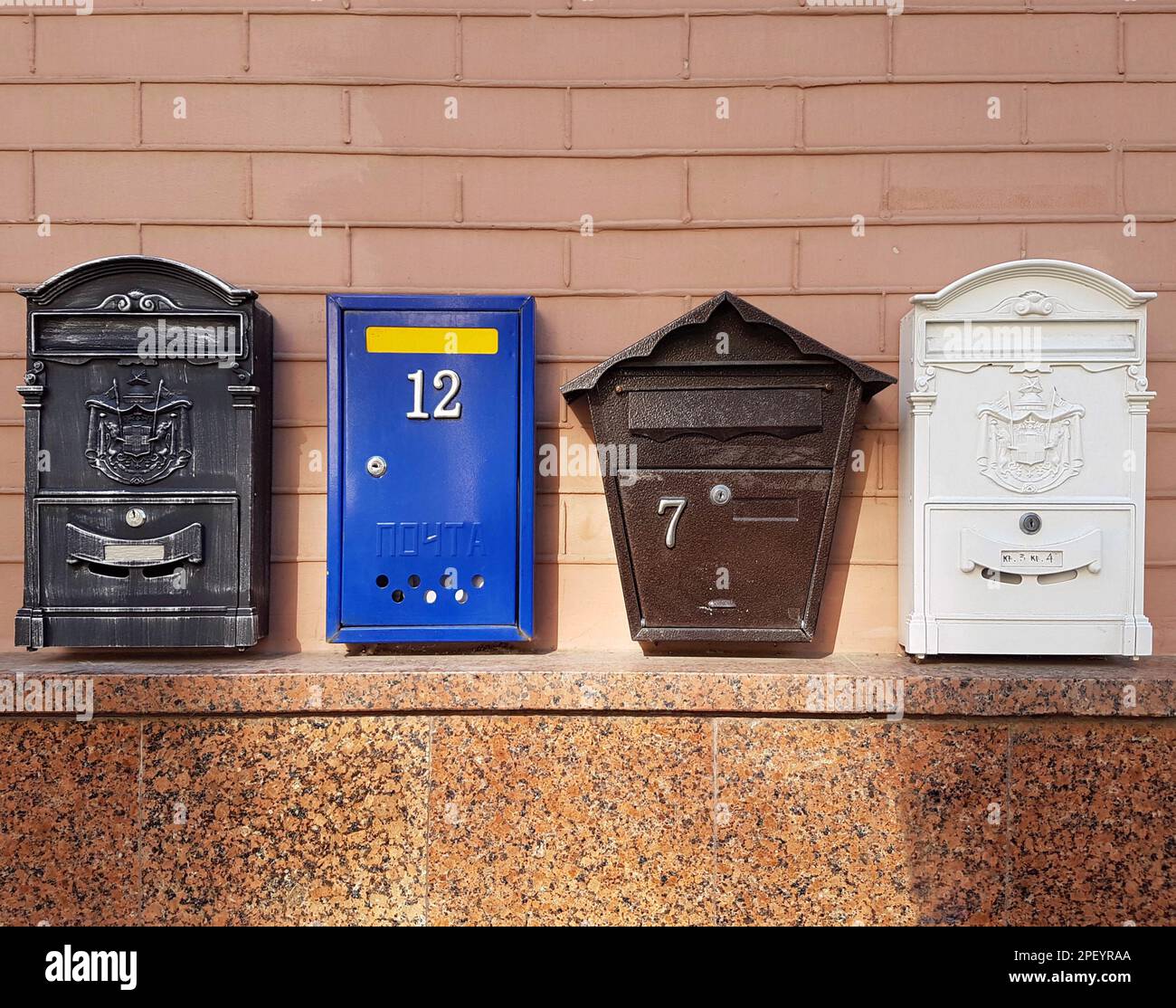 Various beautiful mailboxes on the wall of a brick house Stock Photo ...
