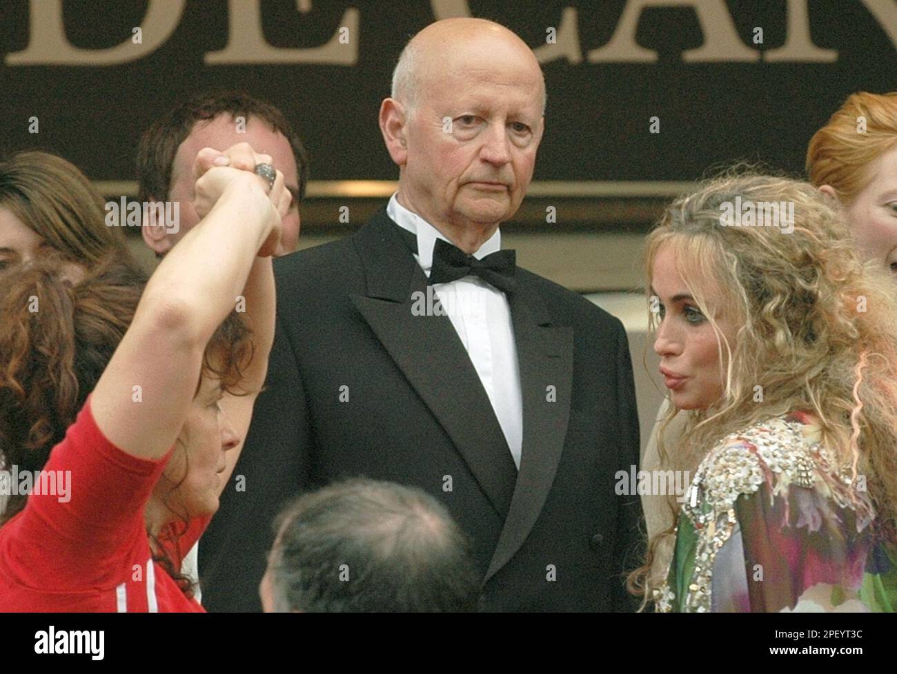 Anne Conti, a French showbusiness worker, left, joins her hands over ...