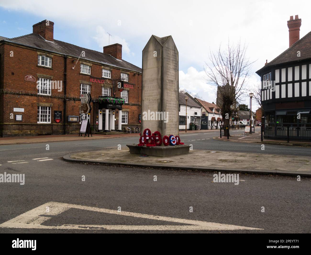 War memorial with red poppy wreaths in Chirk town centre looking ...