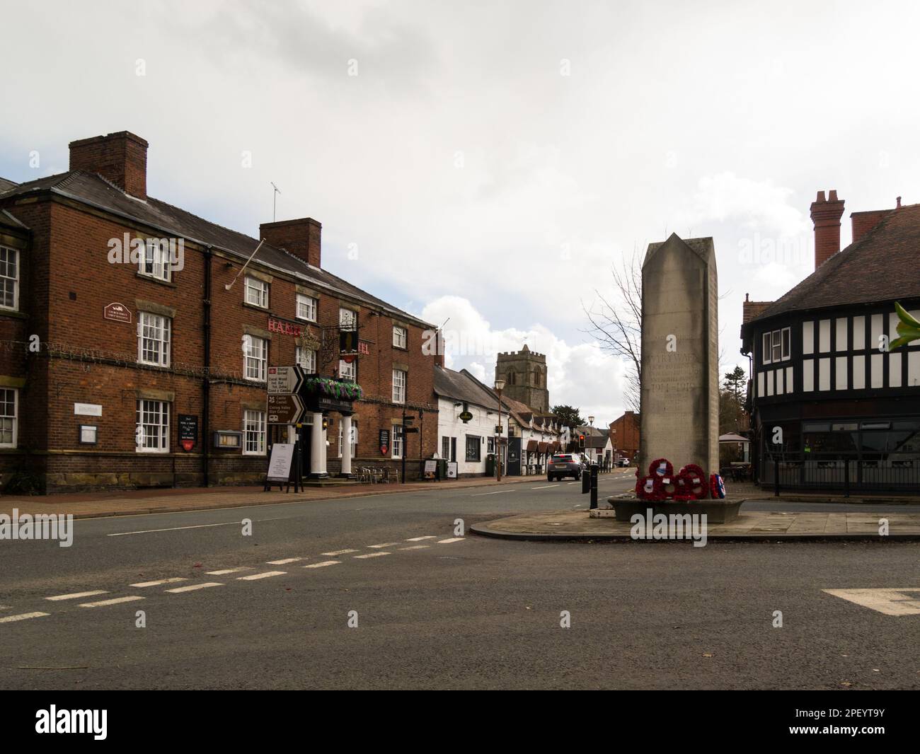 War memorial with red poppy wreaths in Chirk town centre looking ...