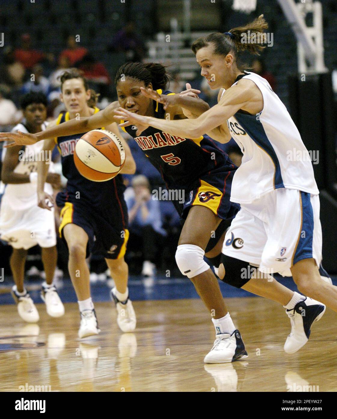 Washington Mystics' Coco Miller, right, goes after a loose ball against ...