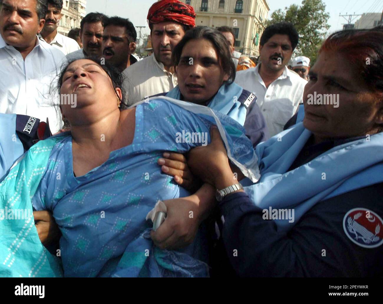 Pakistani women police officers arrest a woman supporter of Pakistan ...