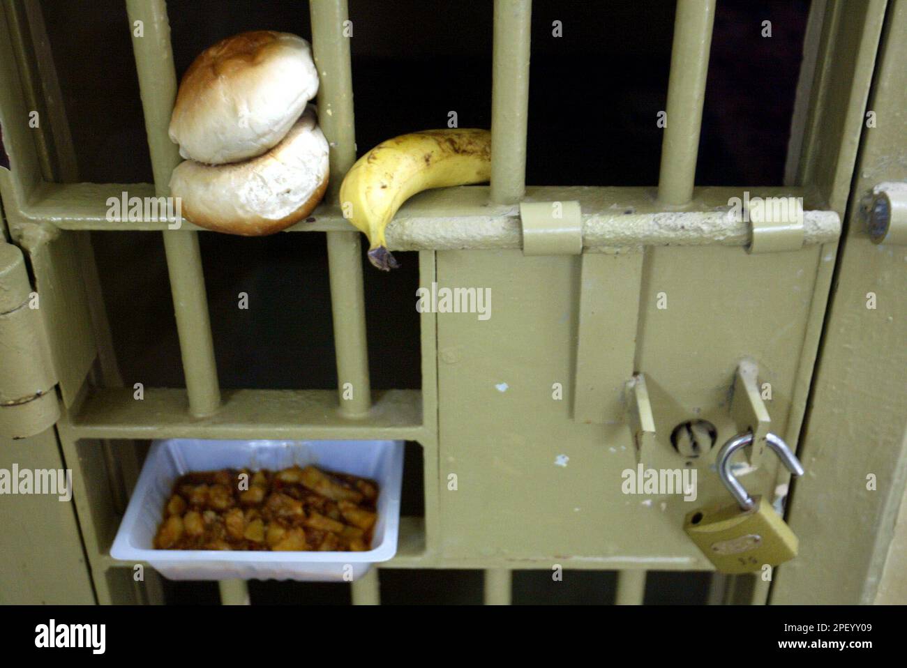 An Iraqi prisoner's dinner sits on the cell door until the prisoner ...