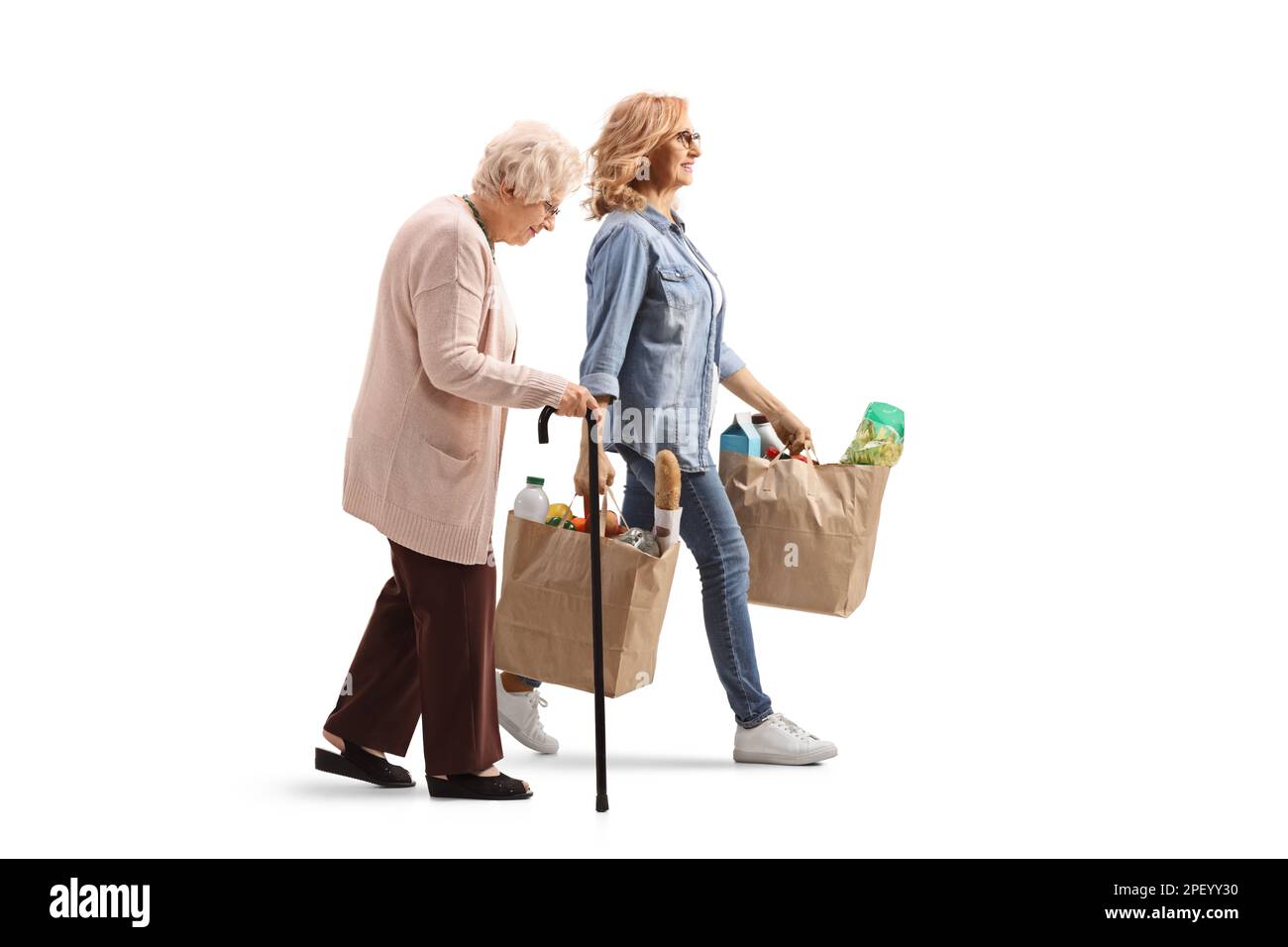Full length profile shot of an elderly woman walking with a cane and ...