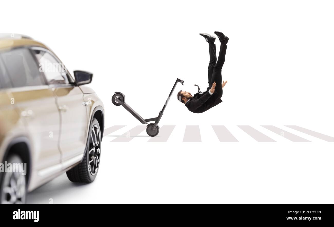 Professional man in a suit and tie falling from an electric scooter at ...