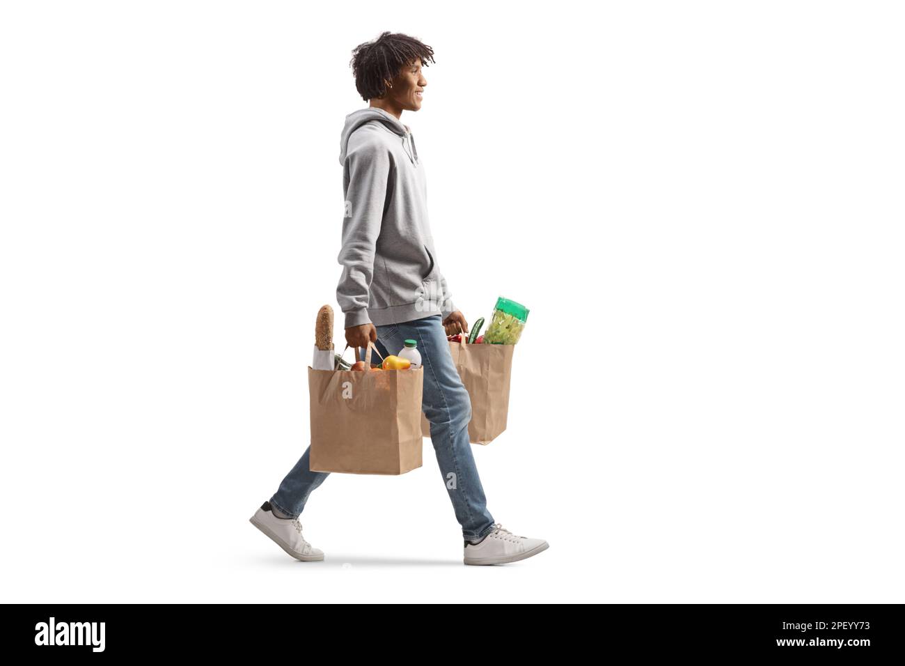 Full length shot of a young african american man carrying grocery bags ...