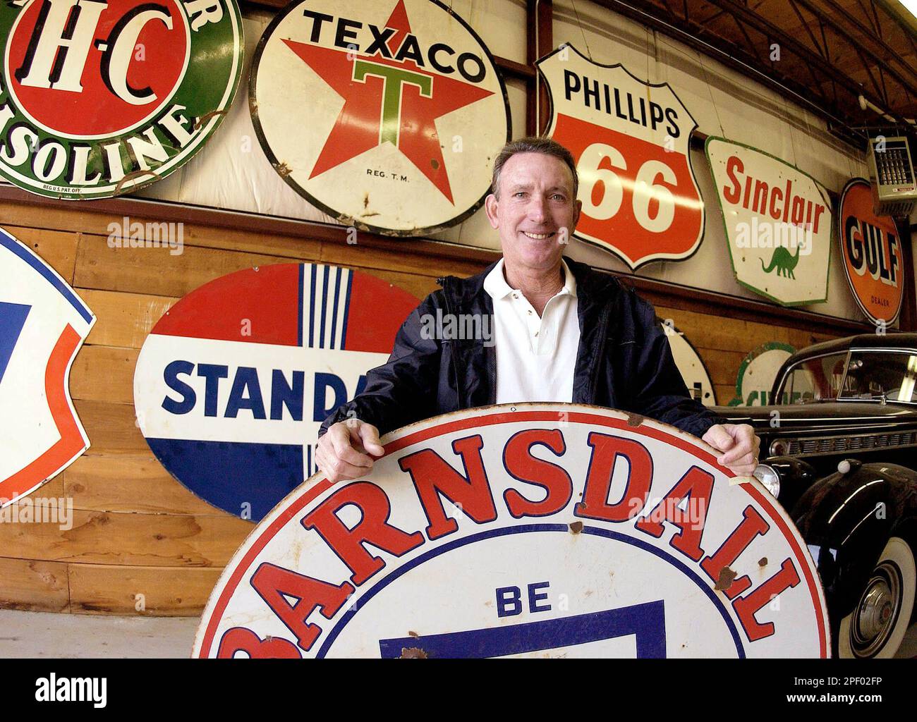 Bill Stokely stands with an old sign on March 12, 2004, in his ...