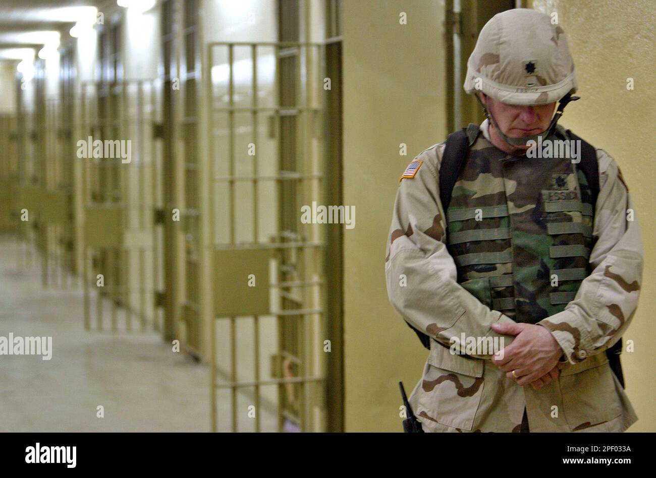 A U.S.soldier walks through the prison of Abu Ghraib, outside Baghdad ...