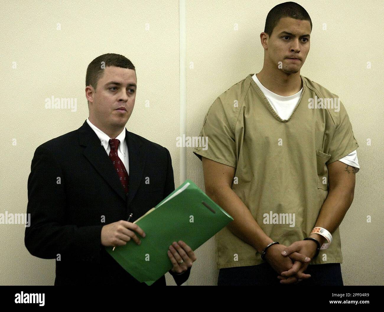 Ohio State football player Louis Irizarry, right, stands in court with ...
